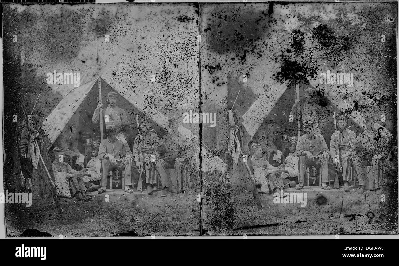 This photograph shows soldiers at a tent, likely during military ...