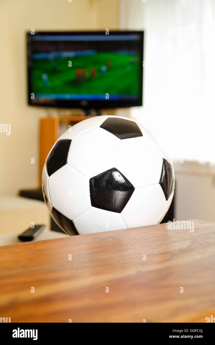 Living room with TV and soccer ball Stock Photo - Alamy