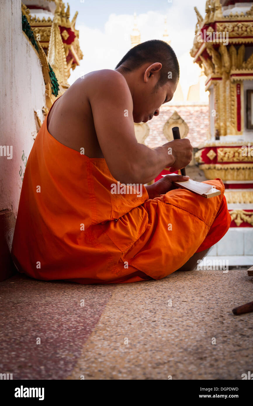 Laos, Vientiane, Monk writing prayers on wood leaf Stock Photo - Alamy