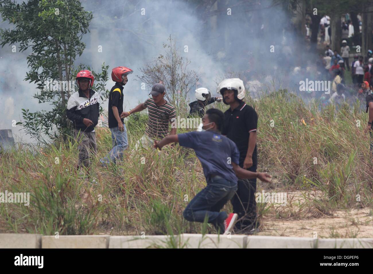 Batam, Indonesia. 23rd Oct, 2013. Protestors throw stones towards ...