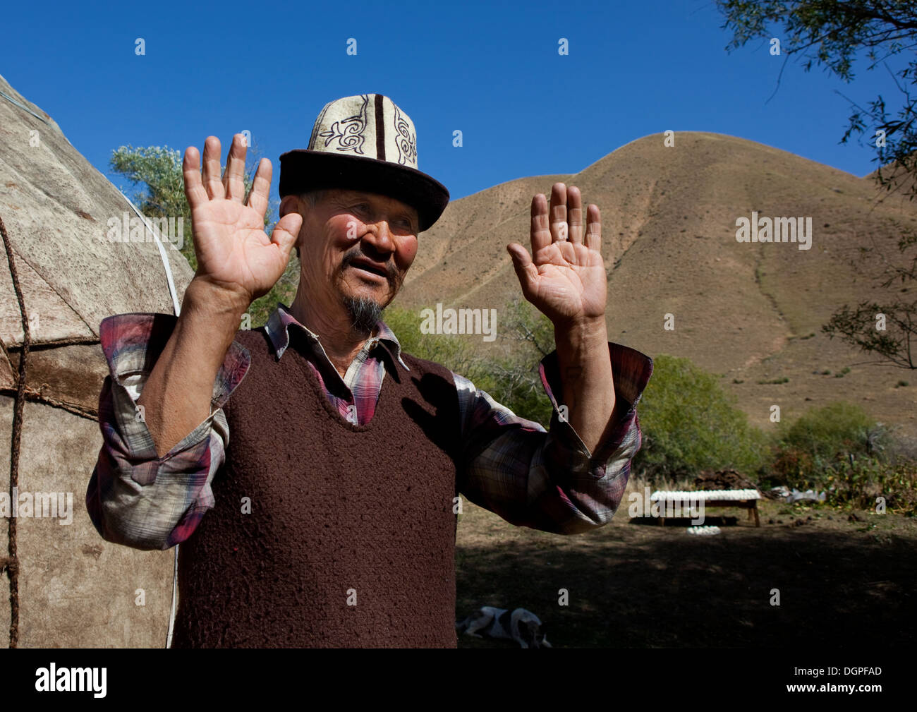 Old Man With Kalpak Hat Throwing Up His Hands, Kyzart River, Kyrgyzstan ...