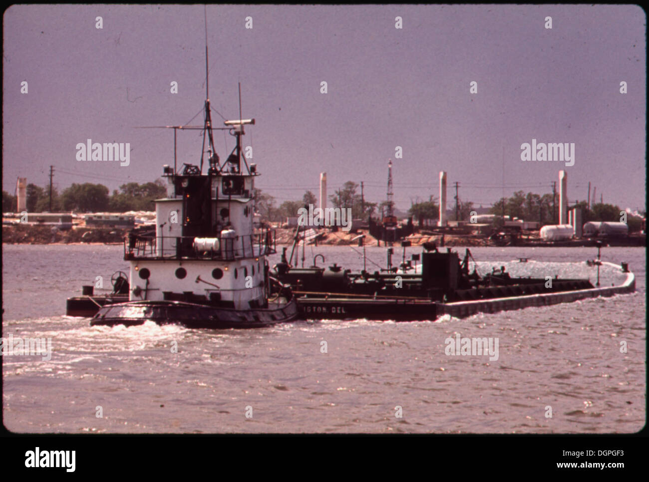 A tugboat maneuvers a barge in Baltimore Harbor, demonstrating the ...