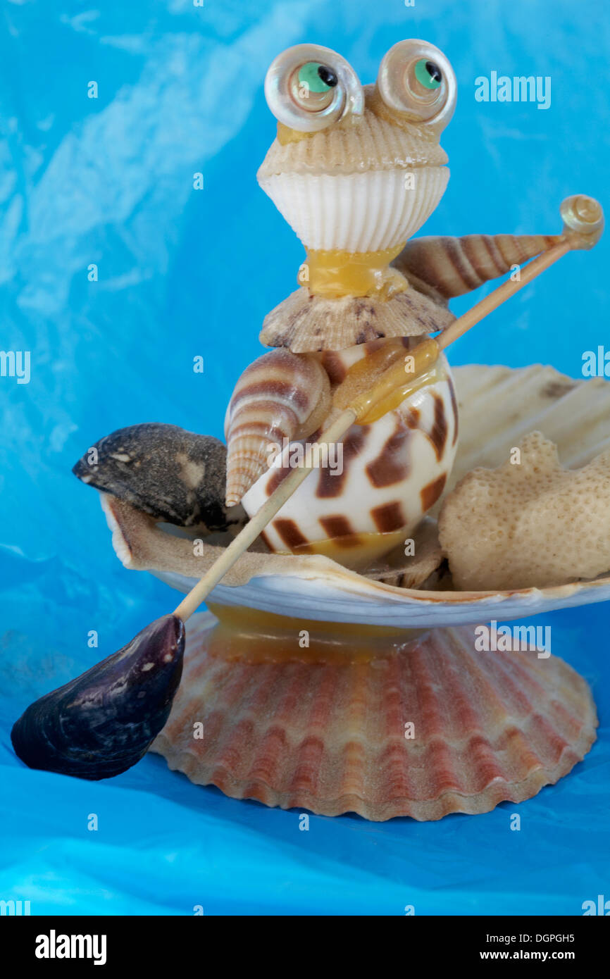 animal made from shells rowing in shell boat set on blue background to ...
