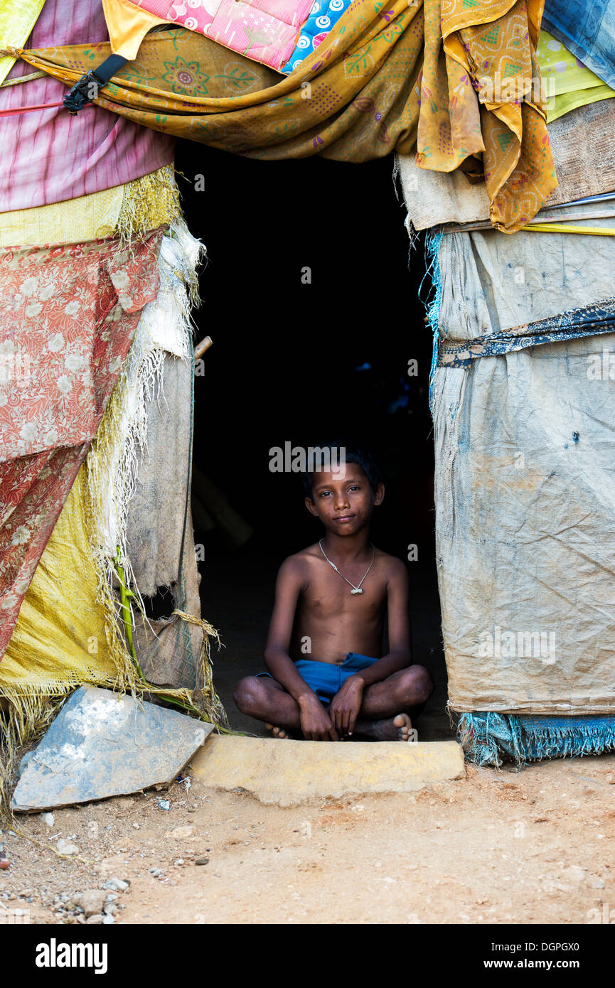Indian lower caste boy sitting inside his bender / tent / shelter. Andhra Pradesh, India Stock ...