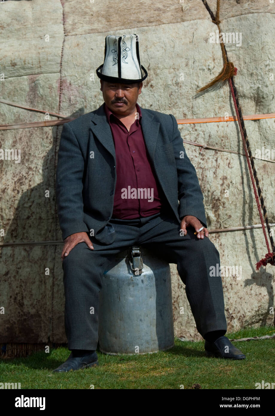 Man With Kalpak Hat Sitting On A Milk Jug, Saralasaz Jailoo, Kyrgyzstan ...