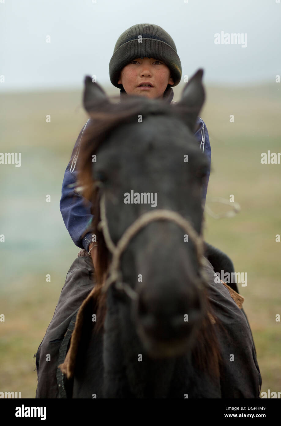 Boy With Wooly Riding A Horse, Saralasaz Jailoo, Kyrgyzstan Stock Photo ...