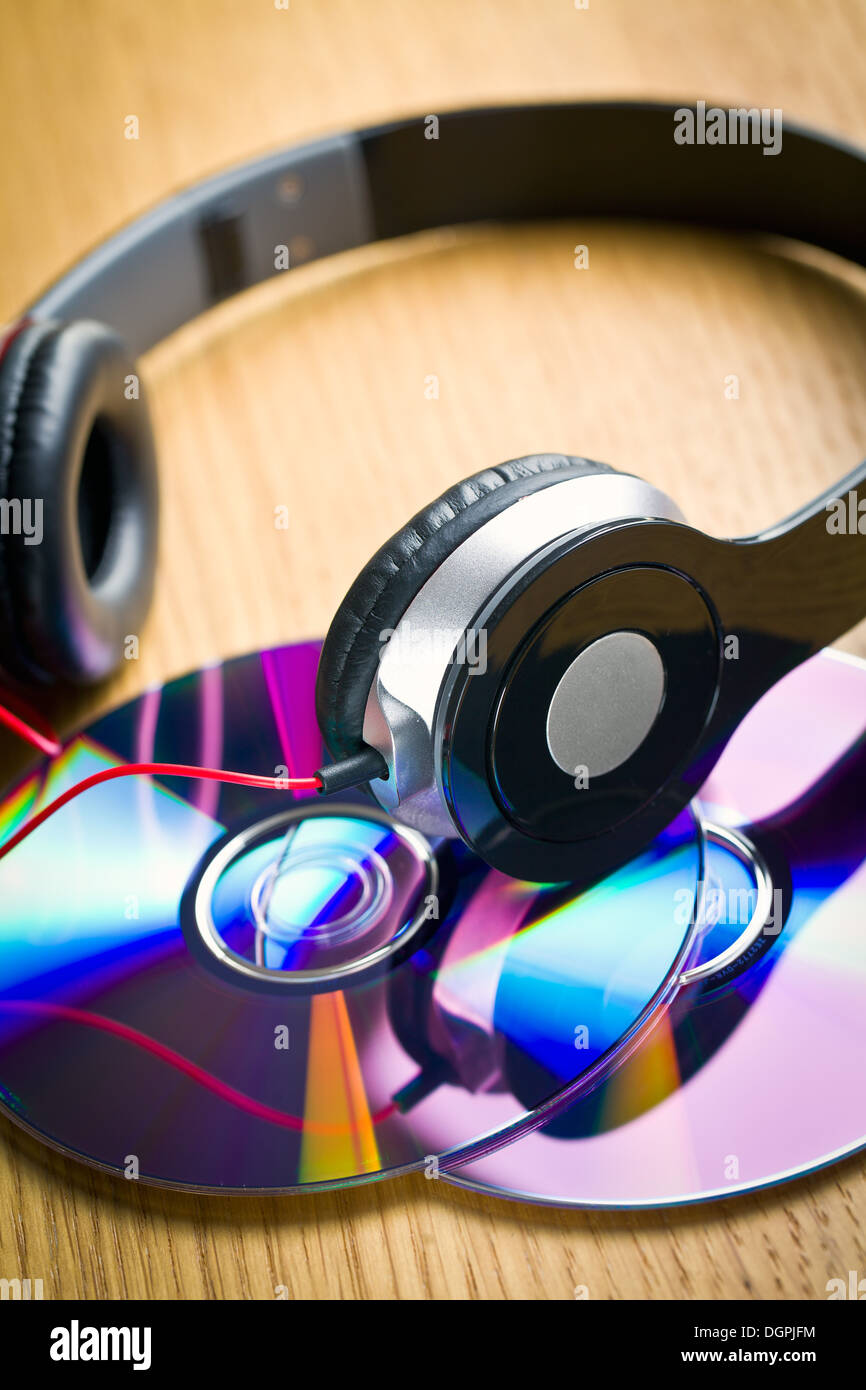 headphones with cd on wooden table Stock Photo - Alamy