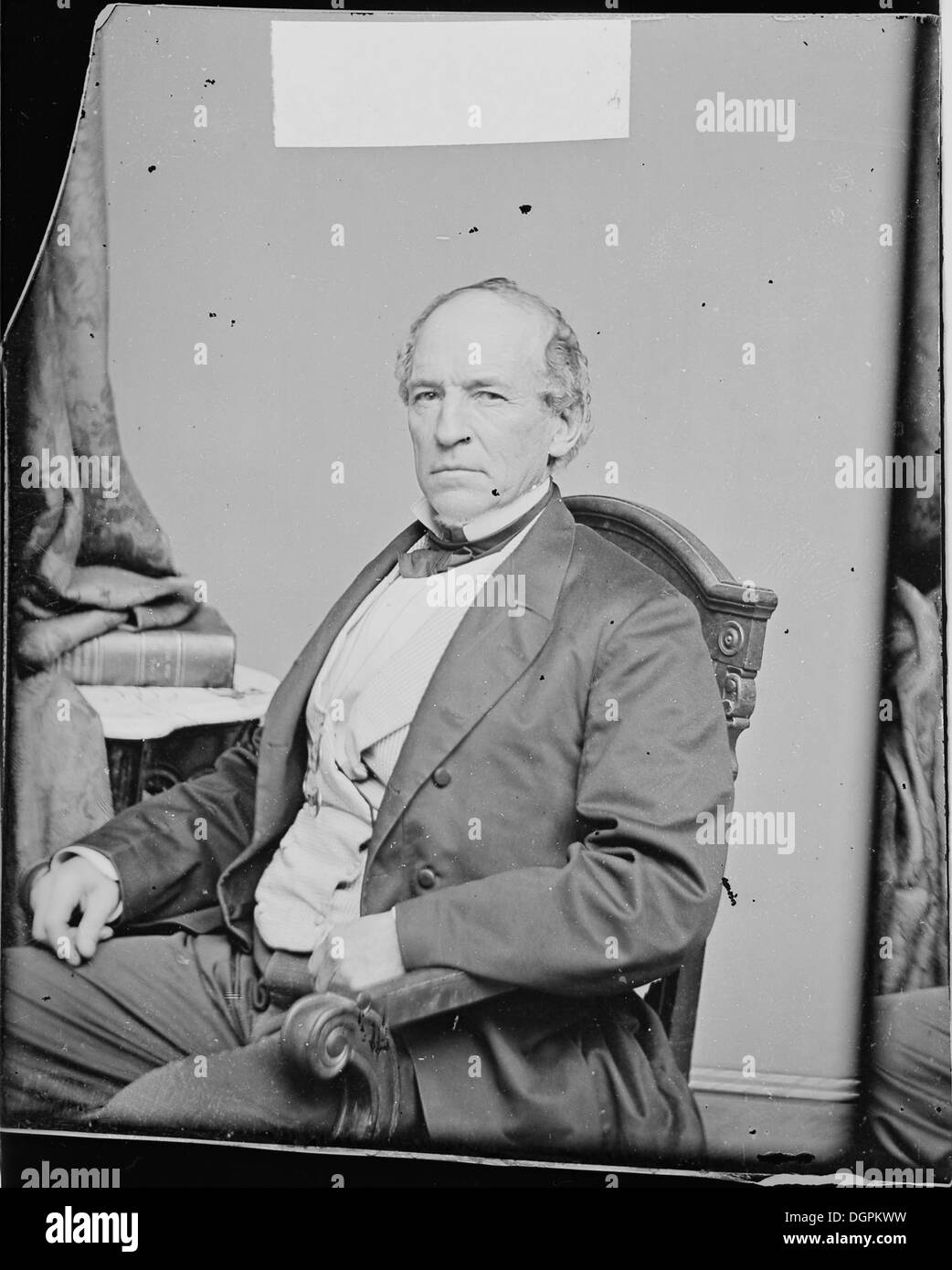 This is a formal portrait of a gentleman, dressed in a suit and tie ...