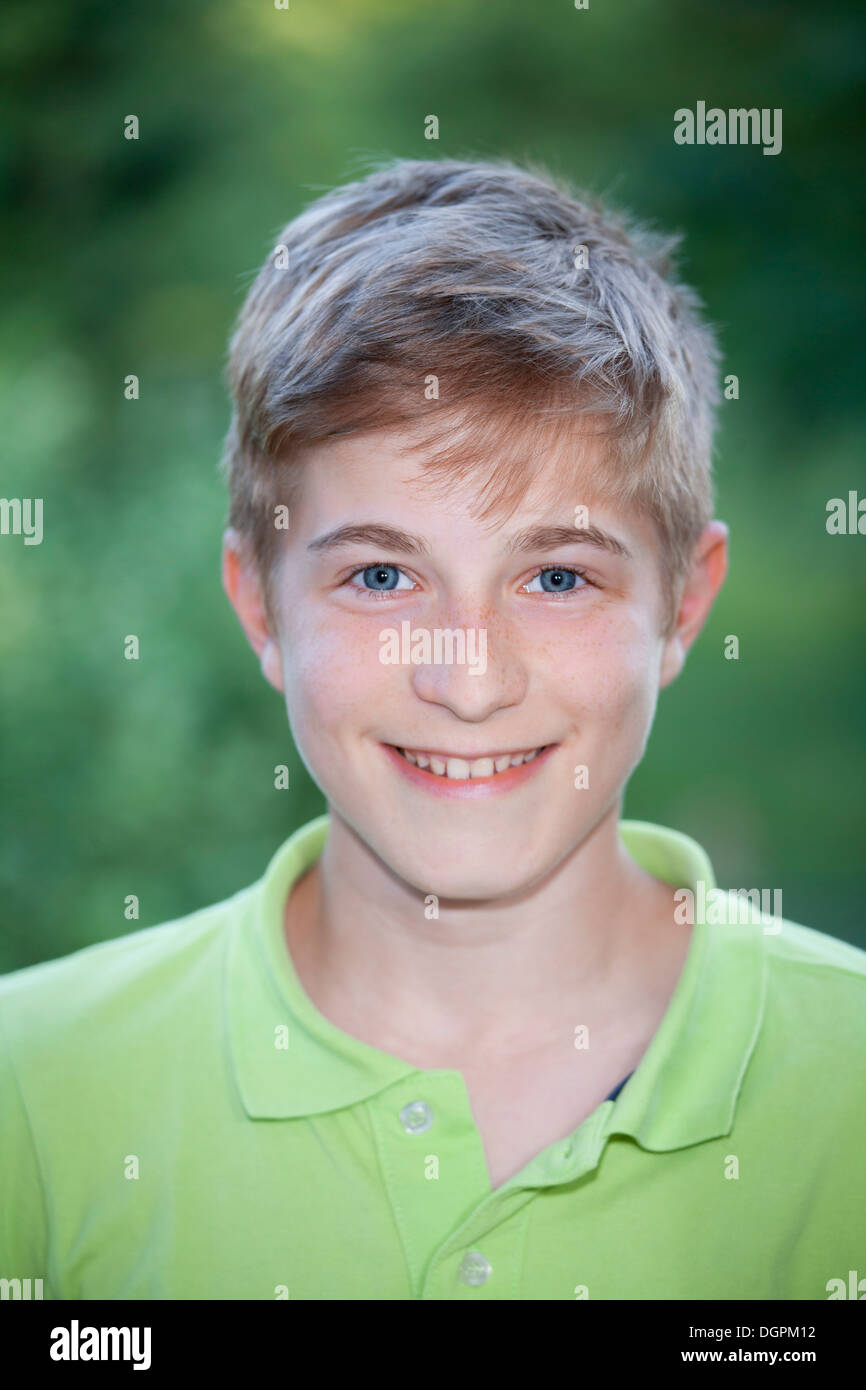 Germany, Bavaria, Munich, Portrait of teenage boy, smiling, close up ...