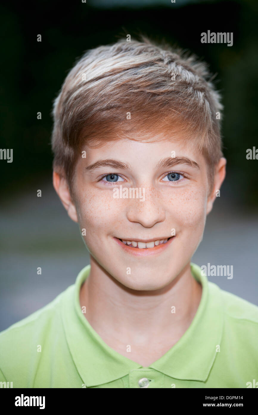 Germany, Bavaria, Munich, Portrait of teenage boy, smiling, close up ...