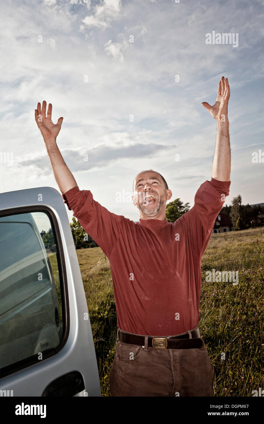 Happy man cheering, standing next to his car Stock Photo - Alamy