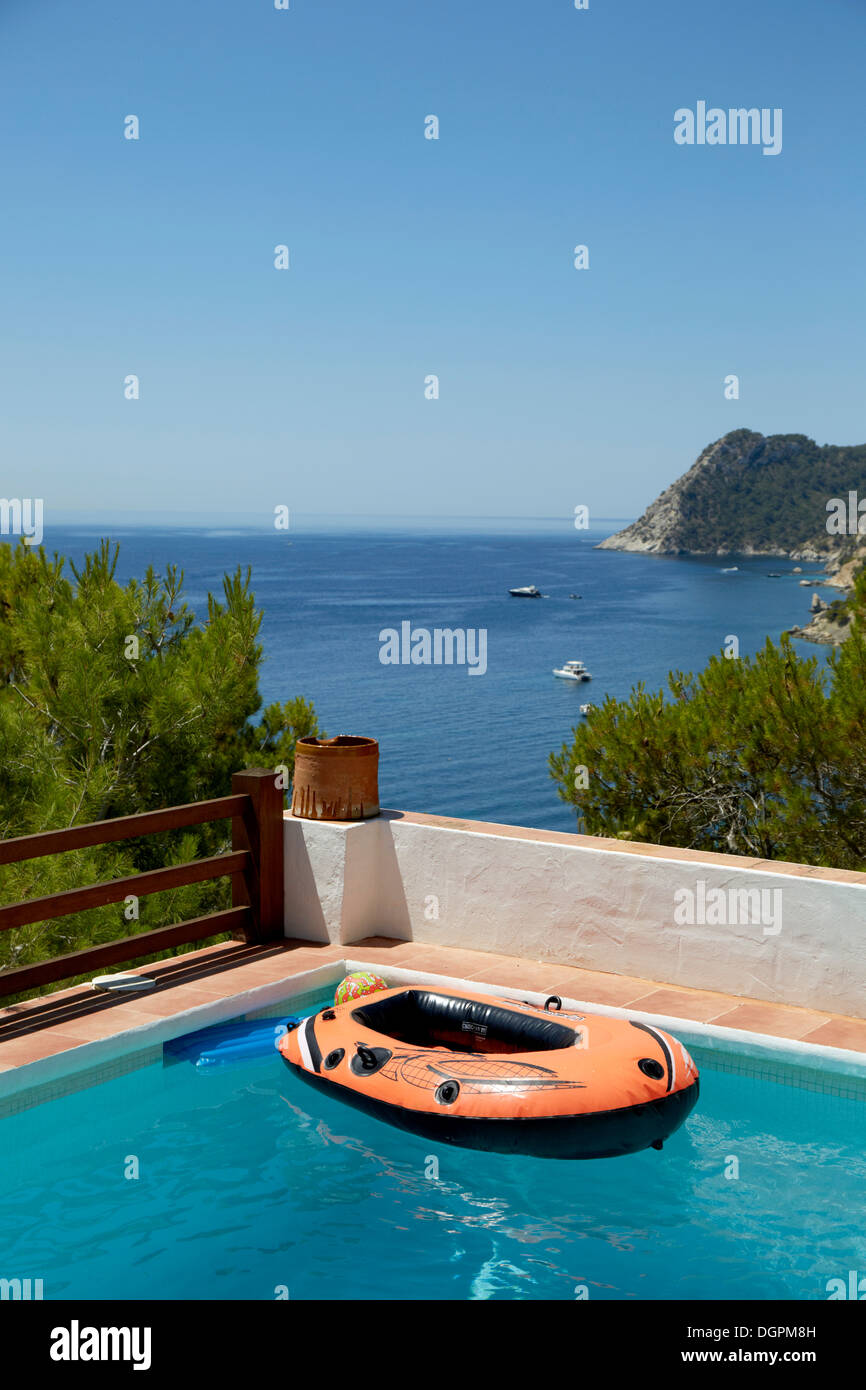 Spain, View of boat in swimming pool with mediterranean finca in ...