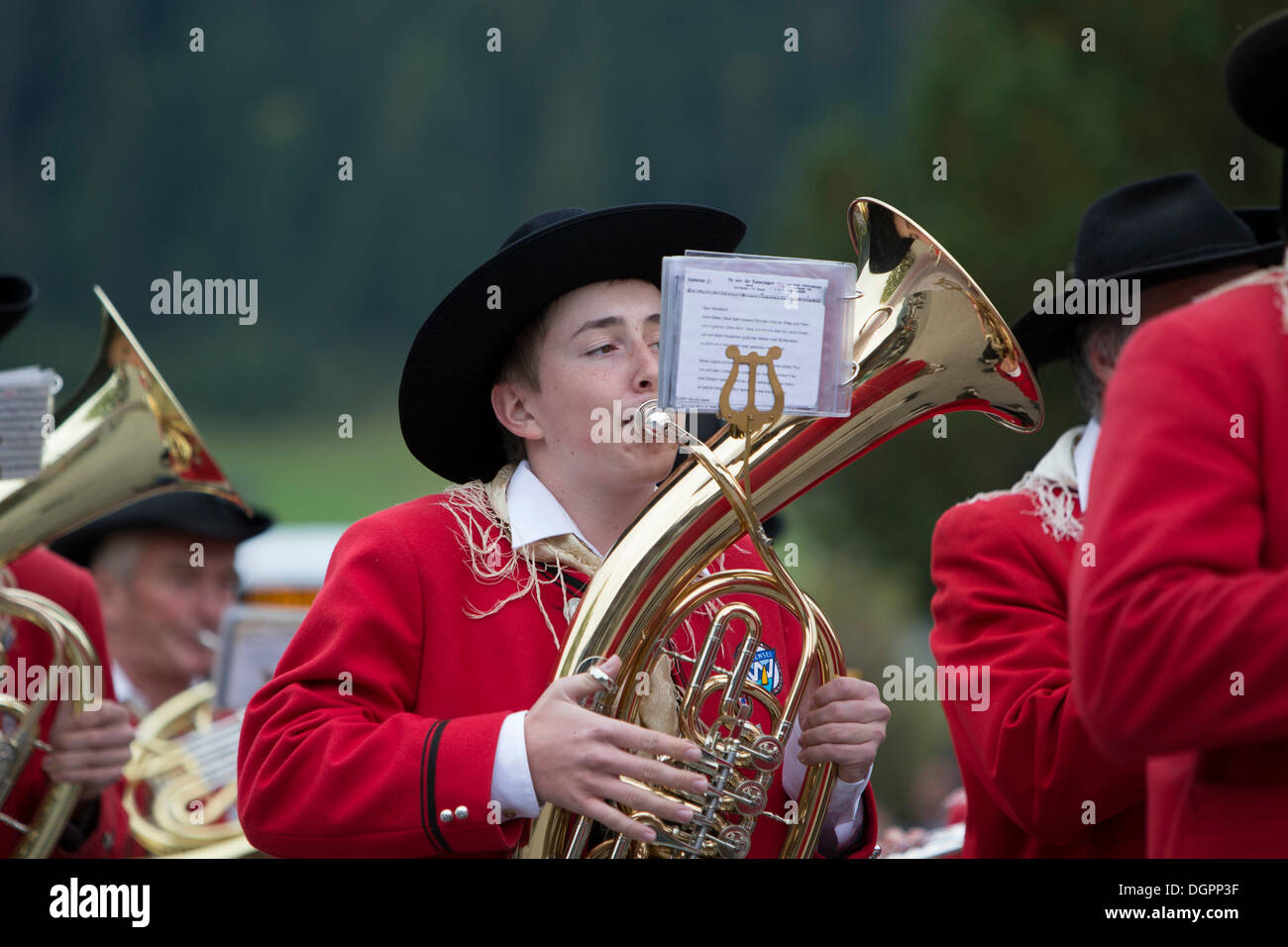 Brass player of the Weissensee marching band in traditional costume ...