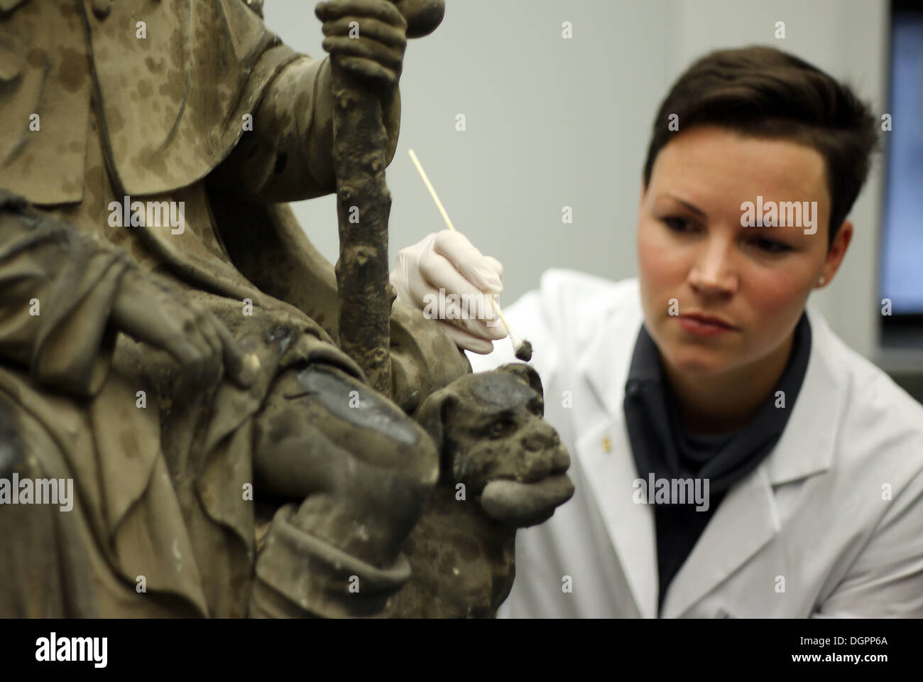 Cologne, Germnany. 24th Oct, 2013. A restorator cleans a figure from ...