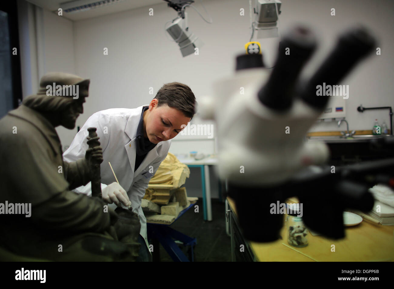 Cologne, Germnany. 24th Oct, 2013. A restorator cleans a figure from ...