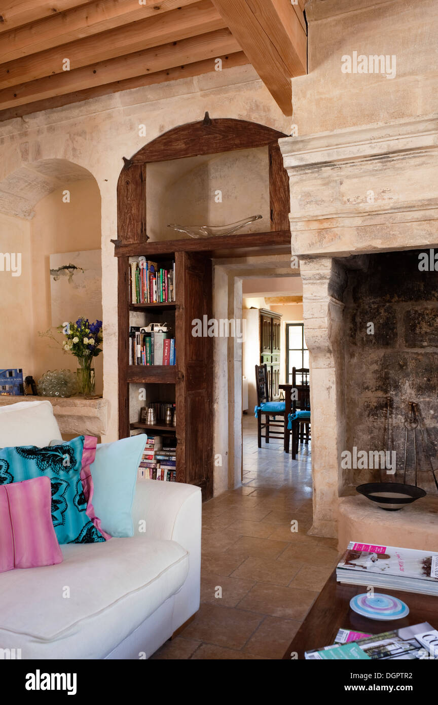 Large open stone fireplace in living room with a white Heals sofa and ...
