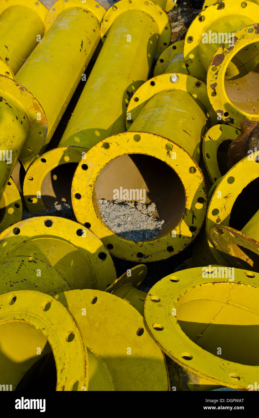 pile of old yellow steel pipe Stock Photo - Alamy