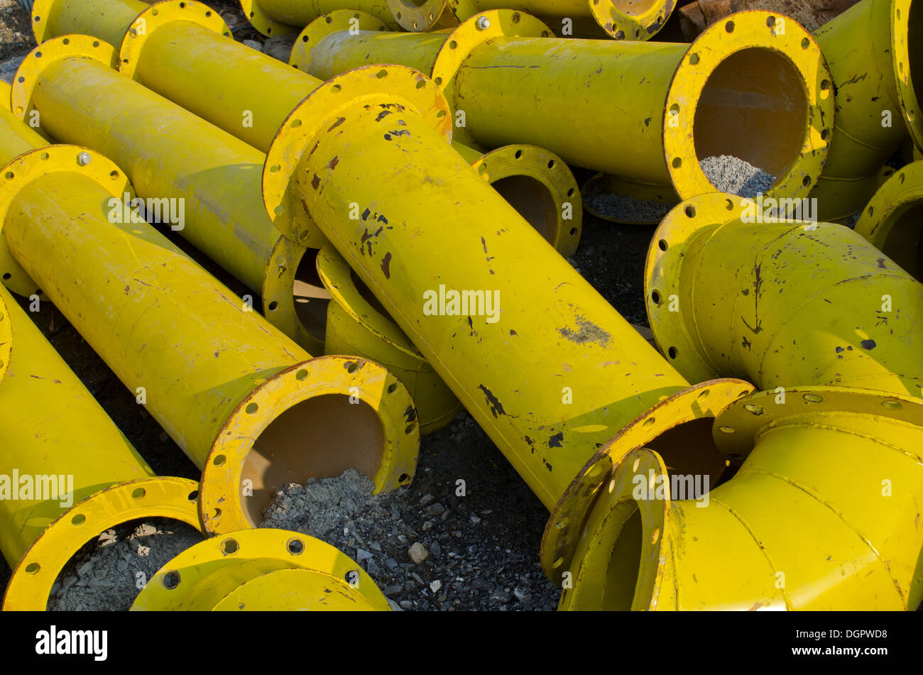 pile of old yellow steel pipe Stock Photo - Alamy