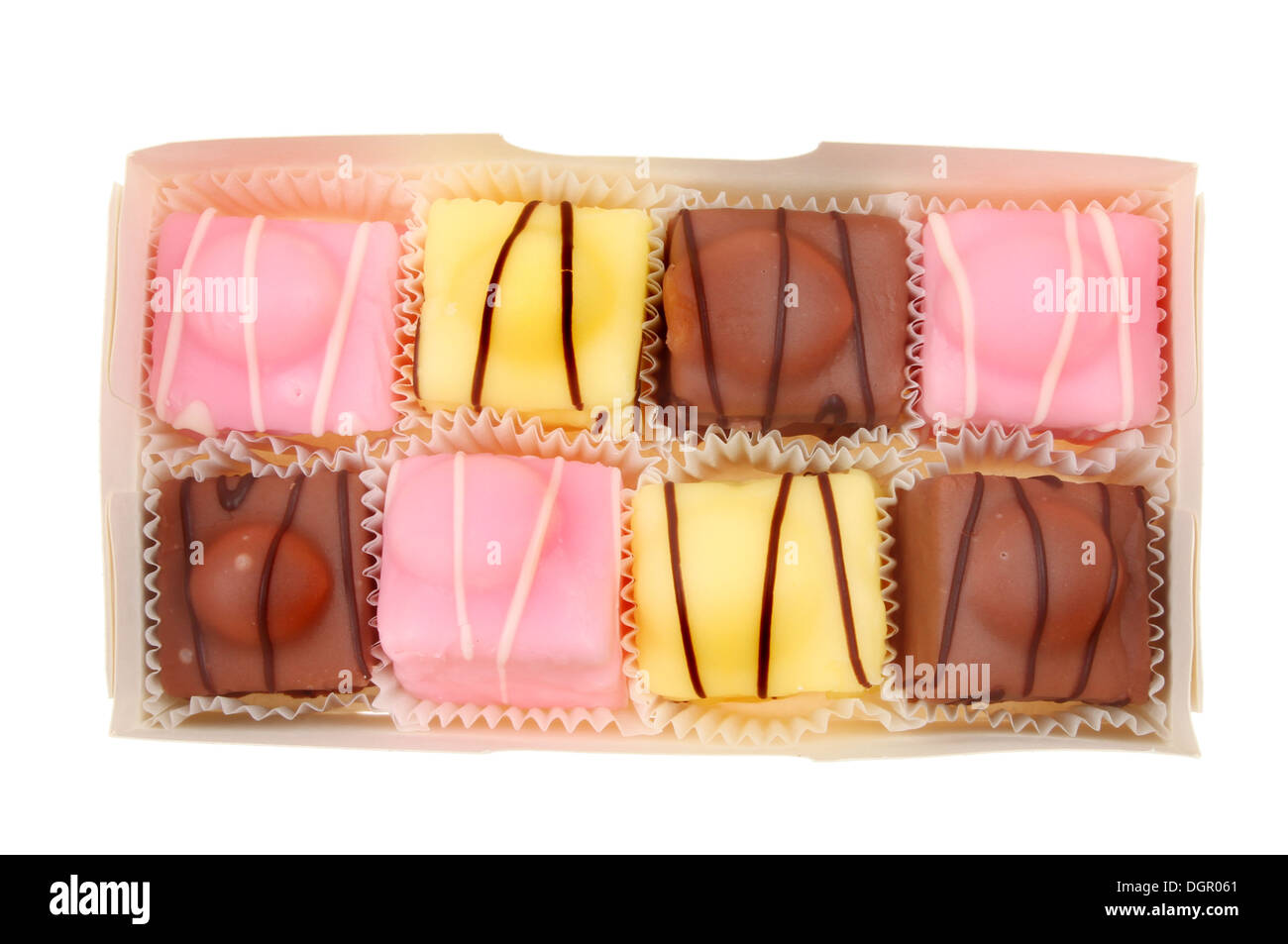 Fondant fancy cakes in a box isolated against white Stock Photo - Alamy