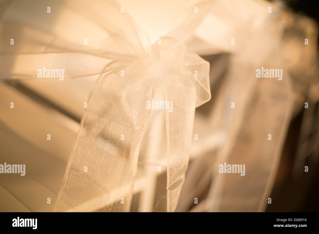 A fancy lace bow on the back of a chair Stock Photo - Alamy