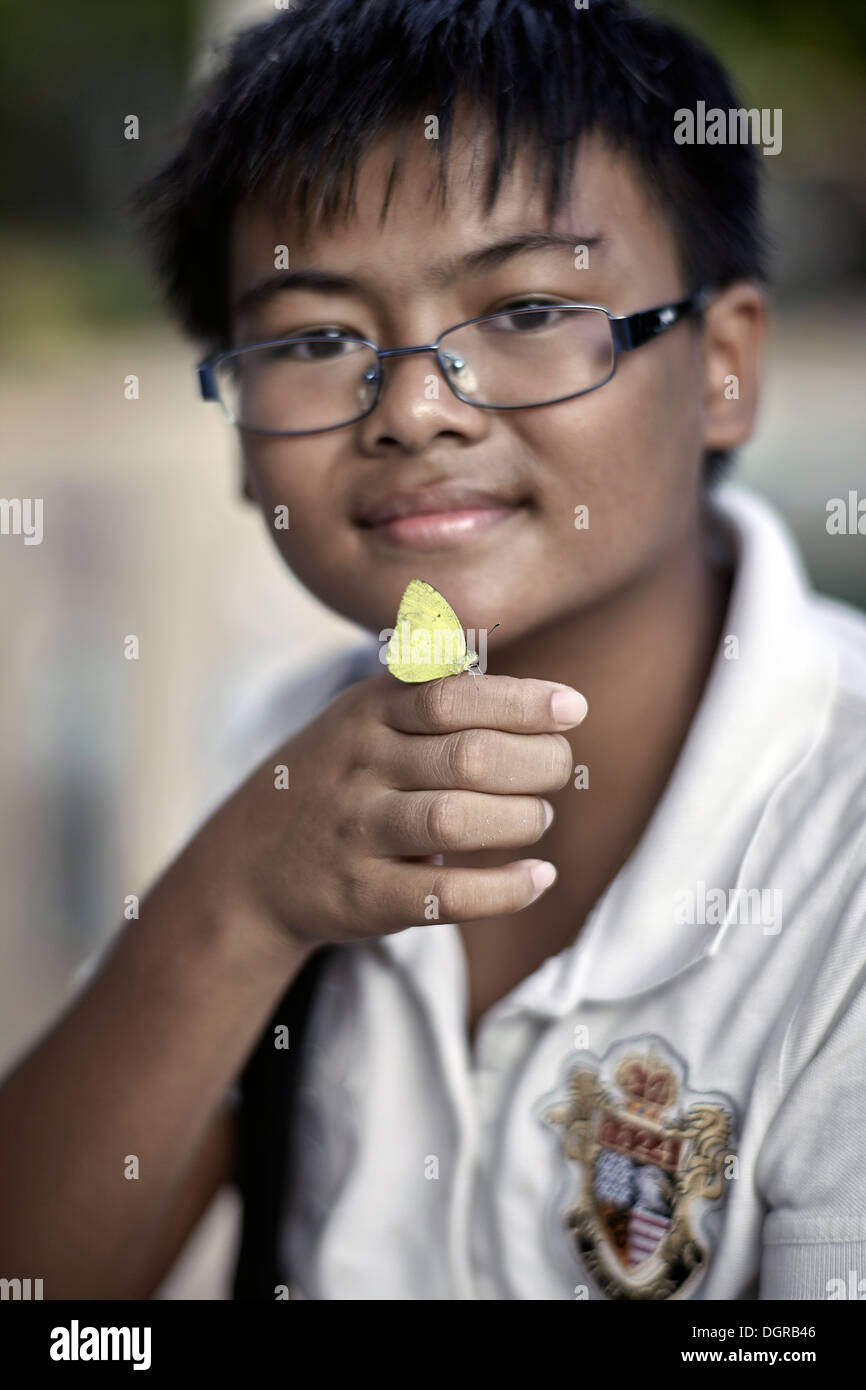 Child butterfly. Young boy and tame butterfly Stock Photo - Alamy