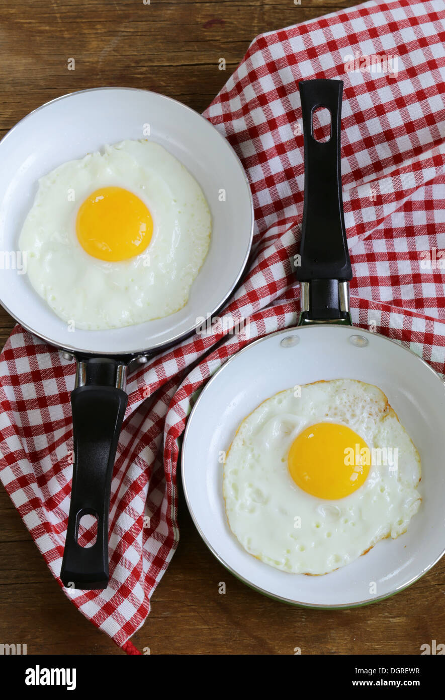 Two pan with fried eggs - breakfast for couples Stock Photo - Alamy