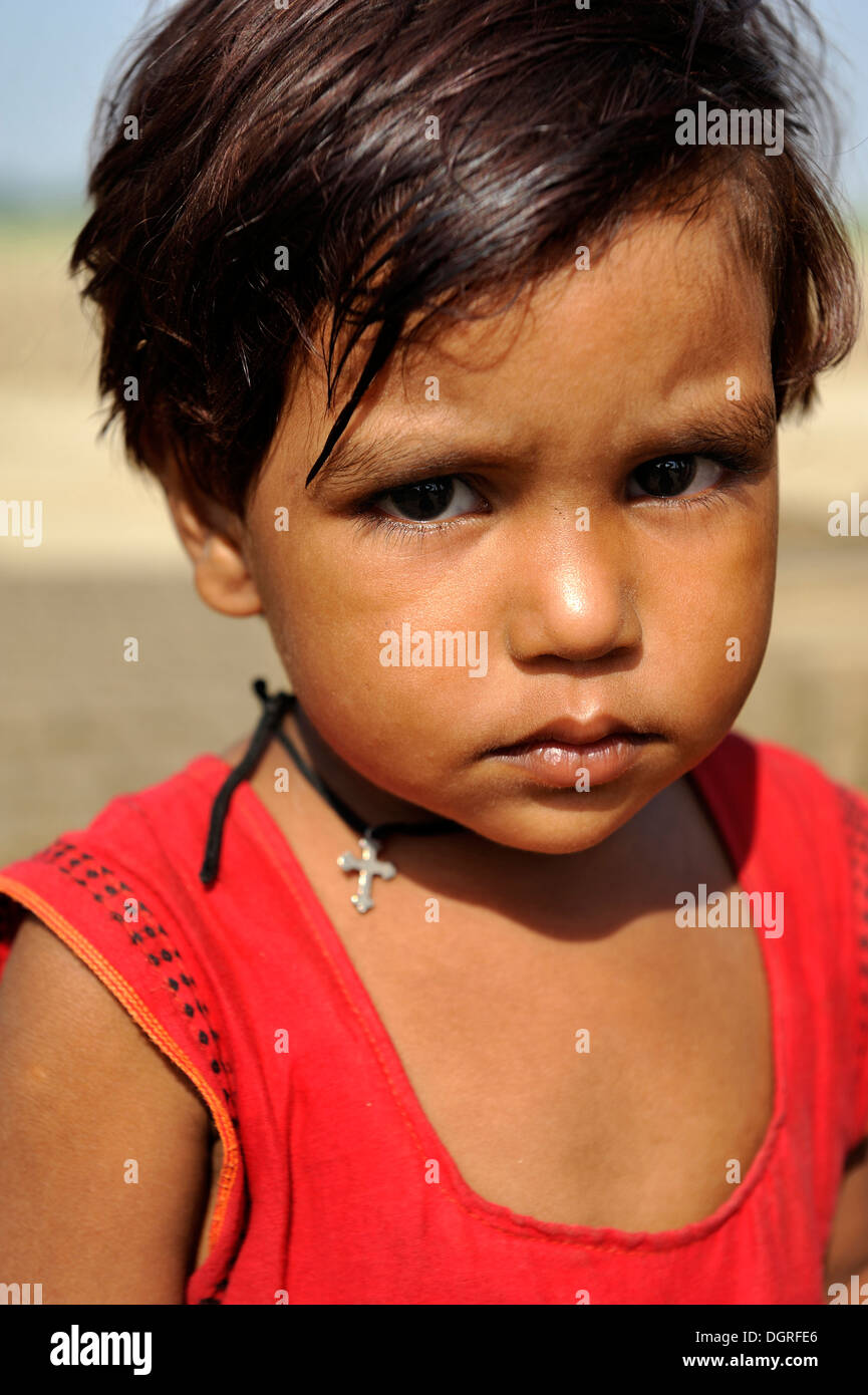 Pakistan, Lahore, Youhanabad II, Portrait of little girl with cross ...