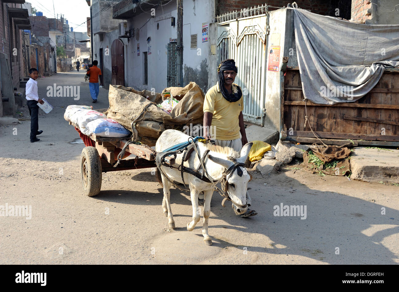 Pakistan, Punjab, Youhanabad, Man transporting goods on wood cart Stock ...