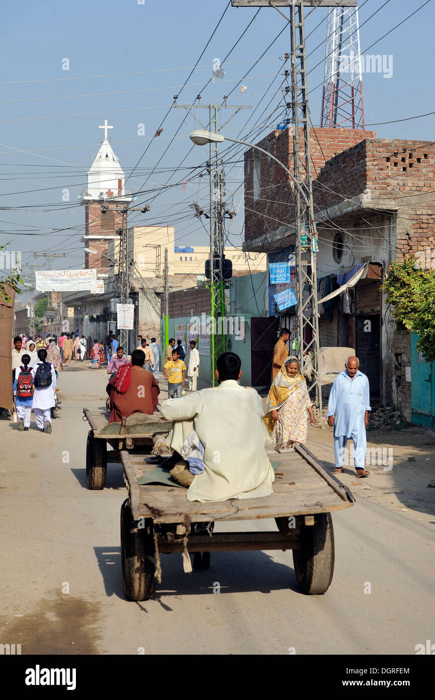 Pakistan, Punjab, Youhanabad, Men transporting goods on wood carts ...