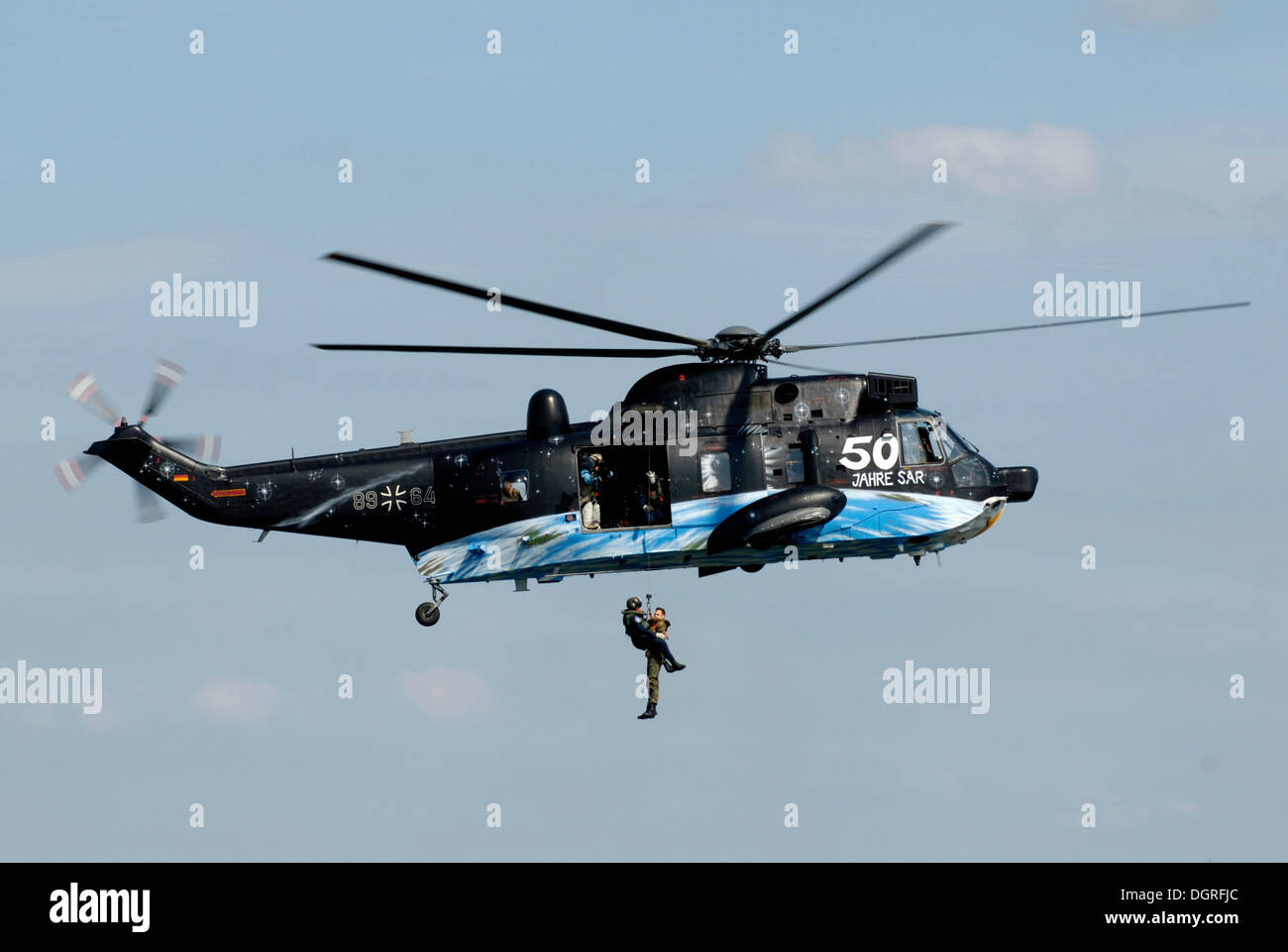 Exercise of a person being rescued by helicopter, Sea King helicopter ...