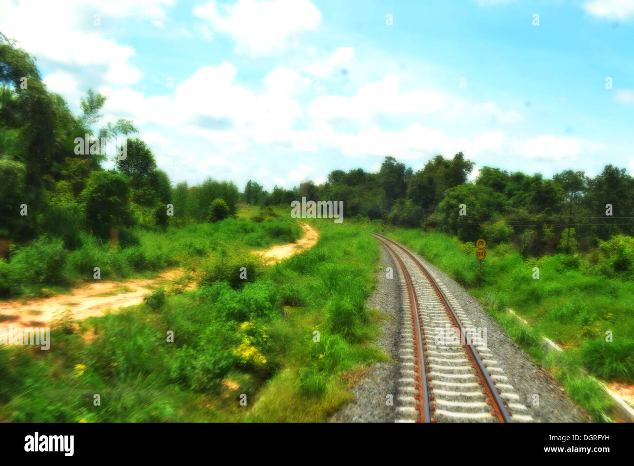 Railway dream.Rails with green meadows Stock Photo - Alamy