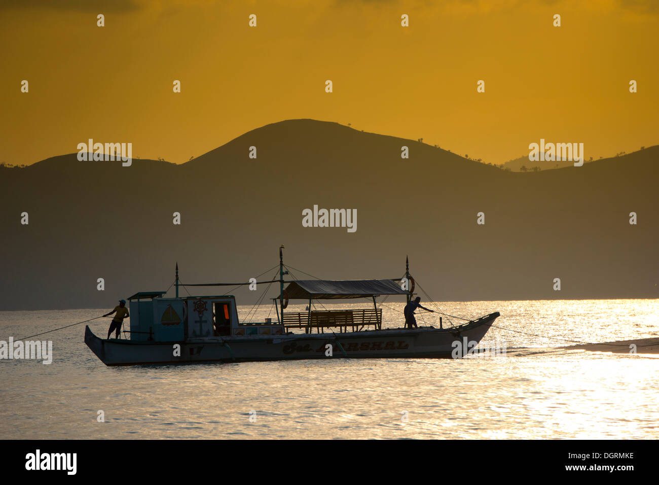 Banka, a traditional Filipino outrigger boat, anchored off the beach in ...
