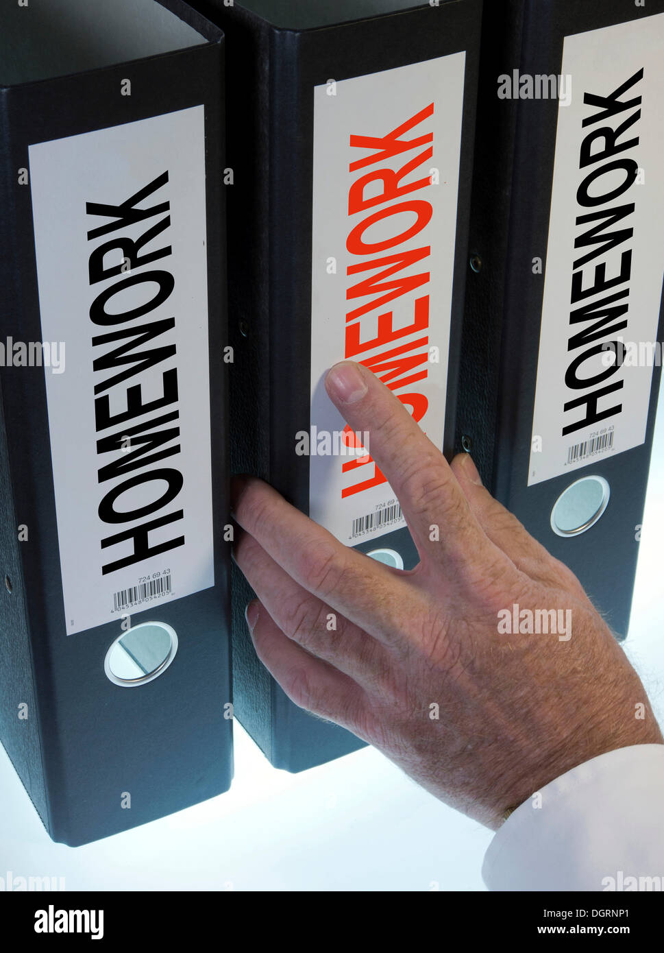 Hand reaching for a file folder labeled "Homework" Stock Photo - Alamy