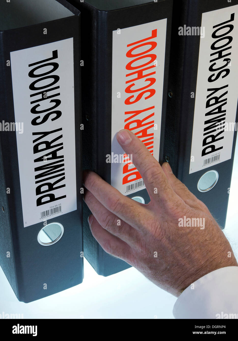 Hand reaching for a file folder labeled "Primary School" Stock Photo ...