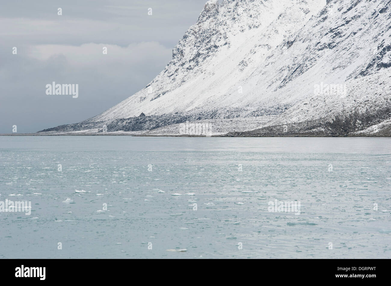 Snow-covered rocks surrounding Magdalene Fjord, Magdalenefjorden ...