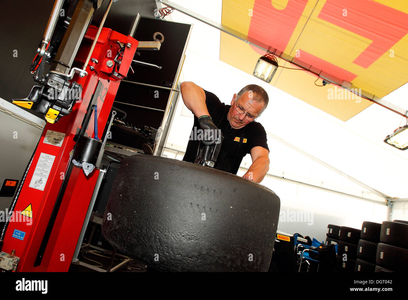 Tire fitter in action during a race at the Nuerburgring race track ...
