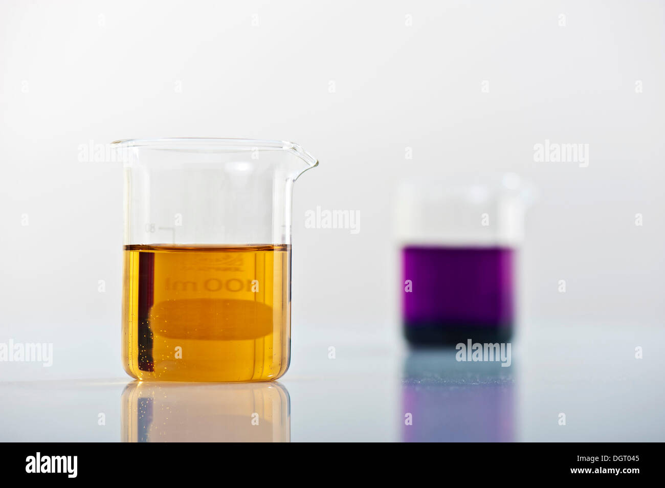 Two flasks filled with coloured chemical liquids Stock Photo - Alamy
