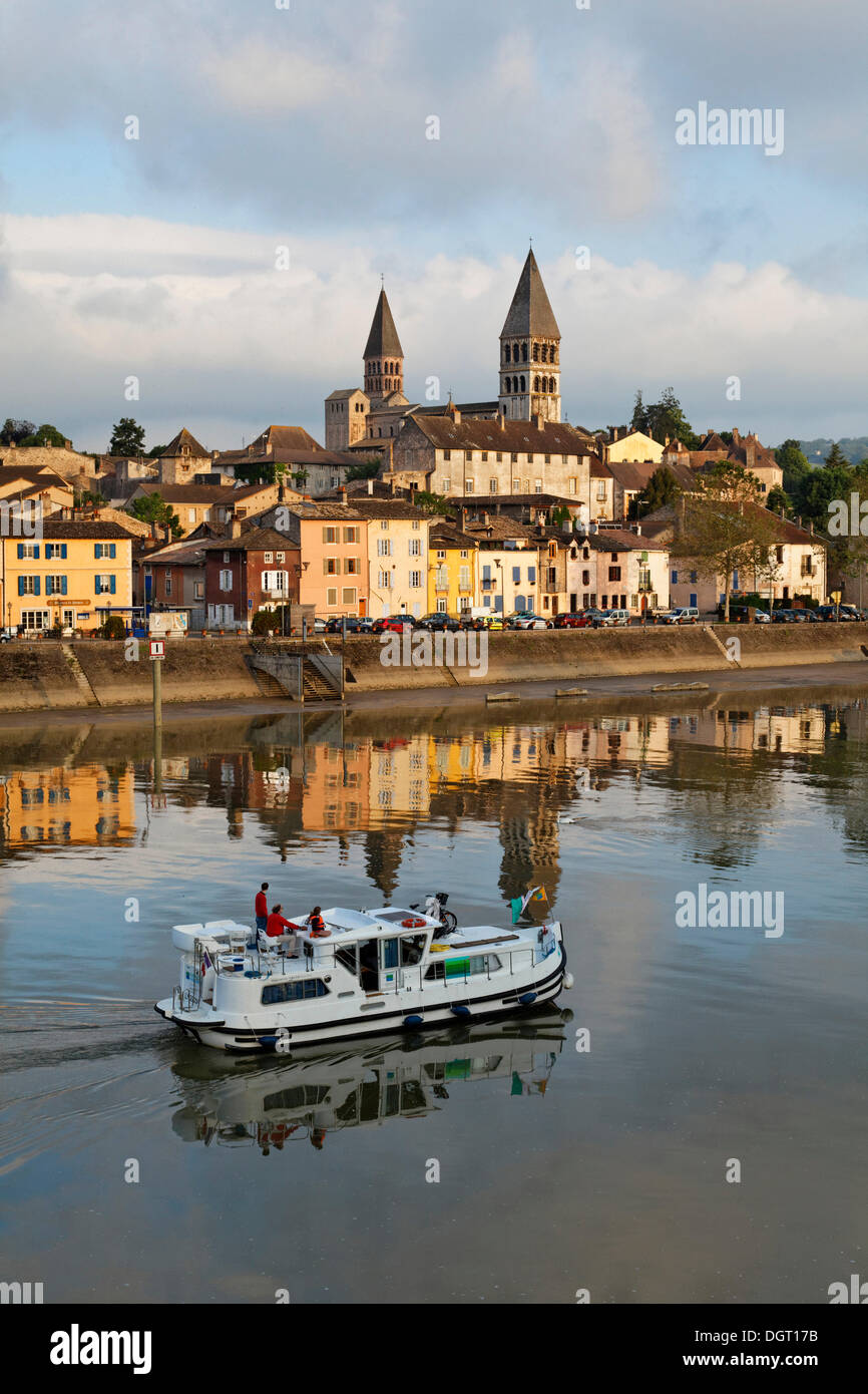 Abbey Church of St. Philibert and Saône river with houseboat, Tournus ...