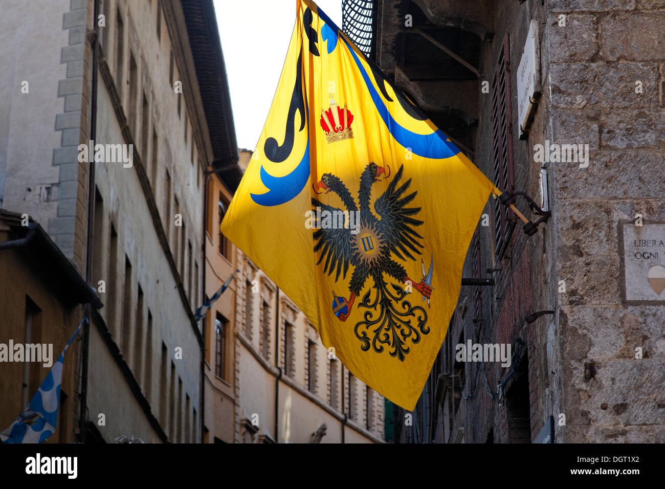 Flag of a contrada district in an alley of the historic town centre ...