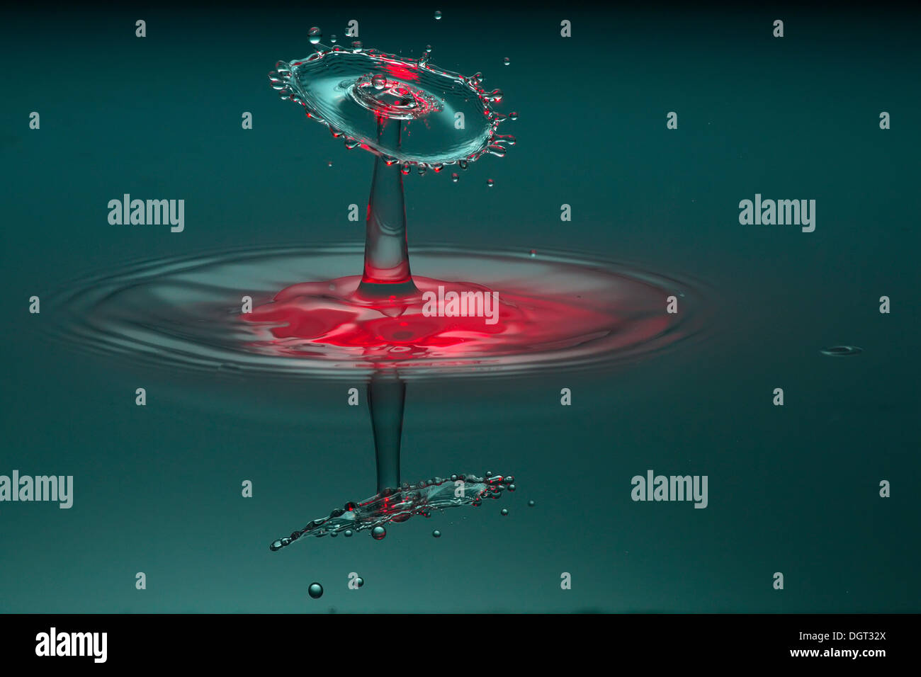 Drop hitting a drop causing a bizarre formation in coloured water Stock ...
