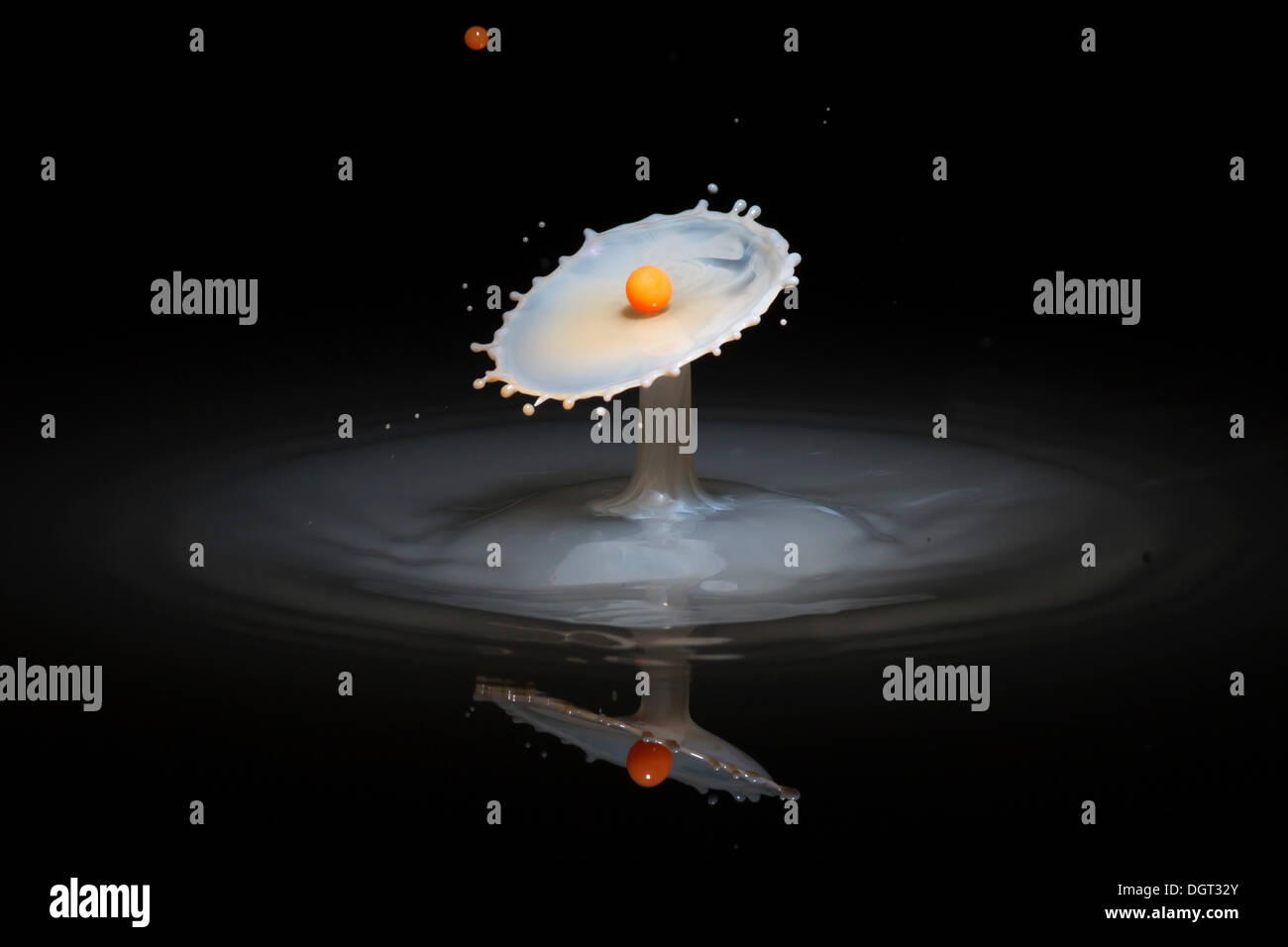 Drop hitting a drop causing a bizarre formation in coloured water and ...