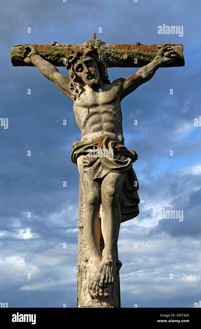 Old stone crucifix against cloudy sky, Illhaeusern, Alsace, France ...