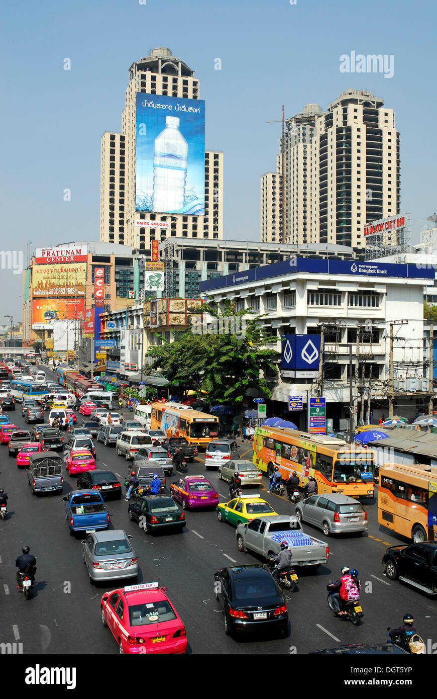 Cars and other city traffic, buildings with advertising in the ...