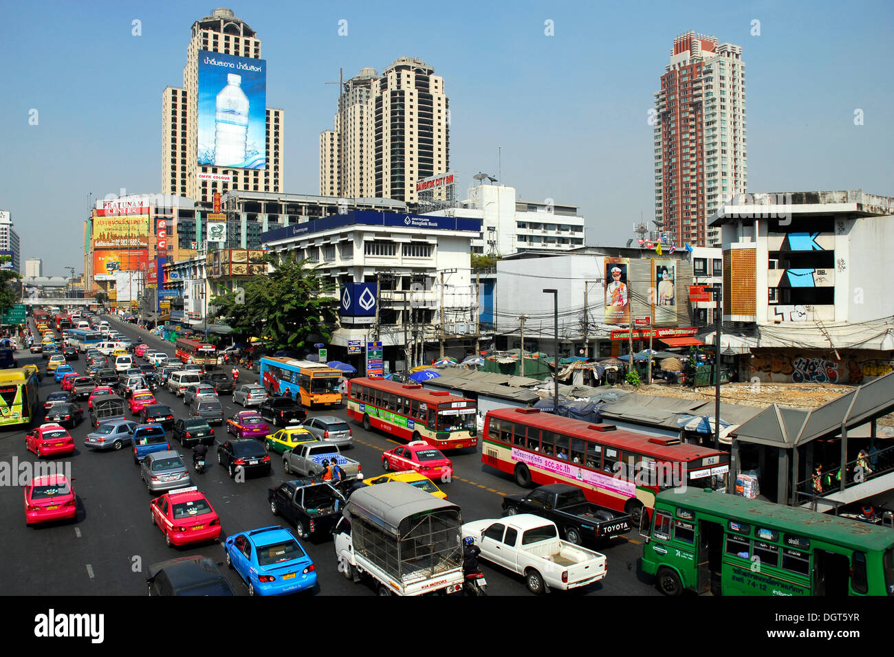 Cars and other city traffic, buildings with advertising in the ...