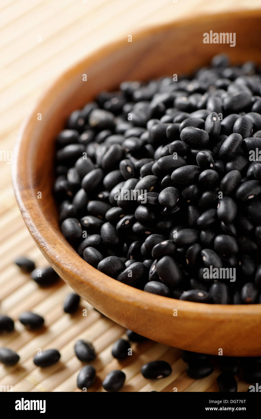 Wooden bowl full of black beans Stock Photo - Alamy