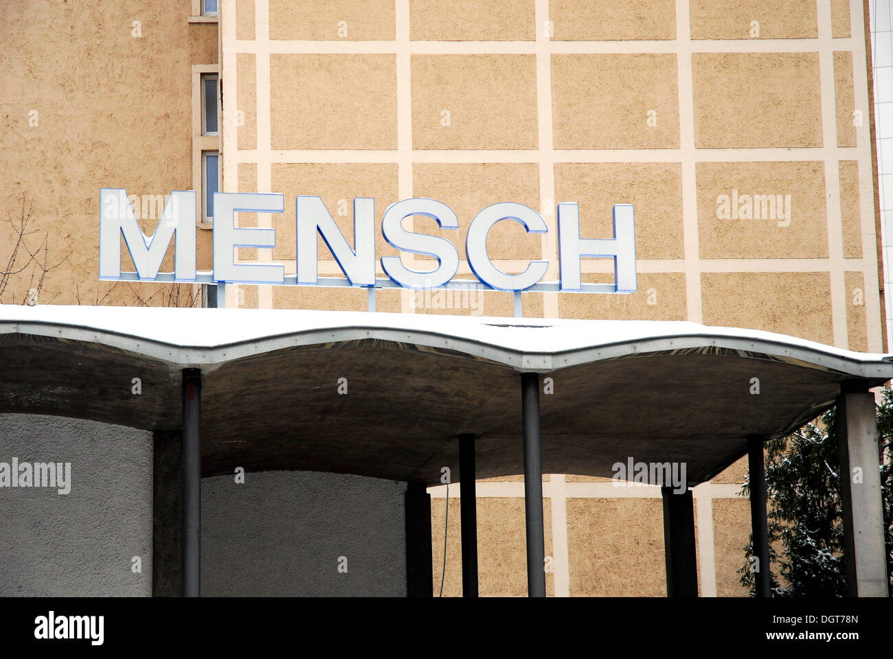 Lettering "Mensch", German for "human being", neon sign on a roof in ...
