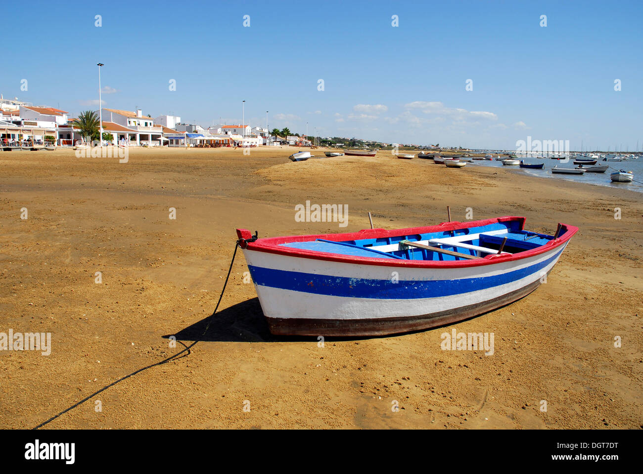 Boat at the Rio Piedras river, ebb tide at the beach in El Rompido ...
