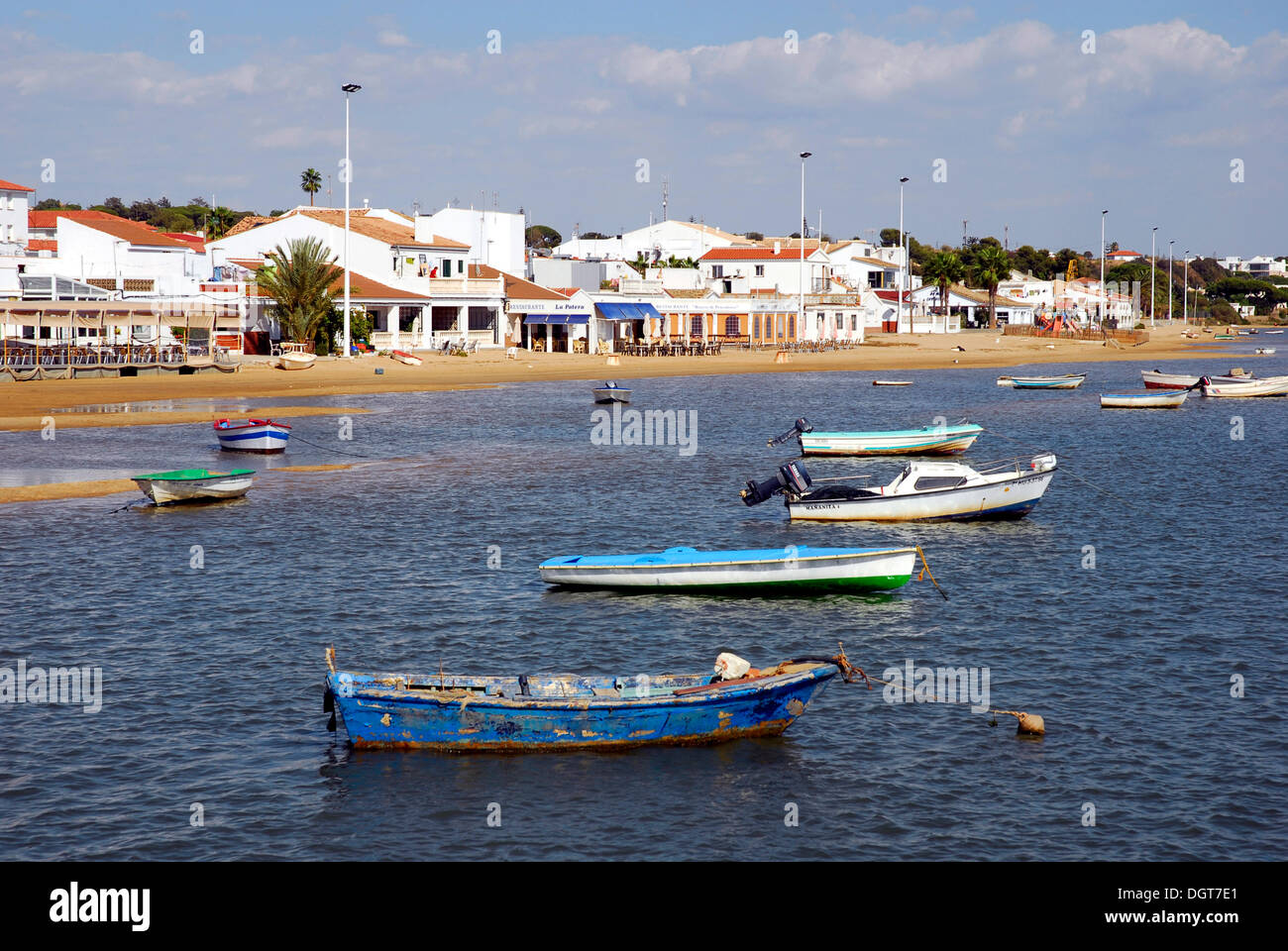 Boats on the Rio Piedras river, restaurants at the beach in El Rompido ...