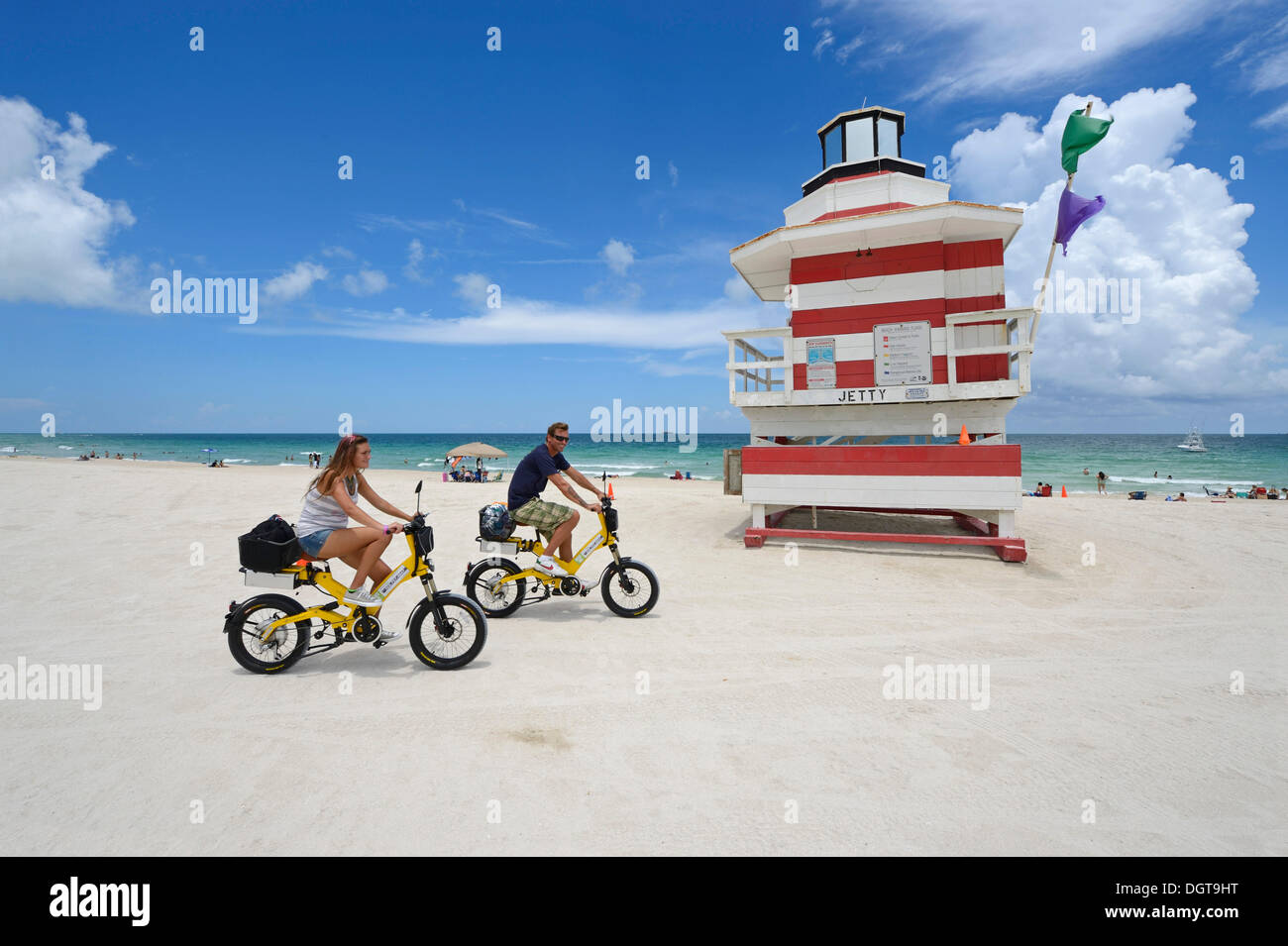 Couple riding electric bicycles, Watchtower, The Jetty, Miami Rescue ...