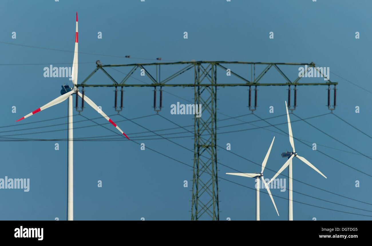Wind wheels rotate behind a high-voltage line near Petersdorf, Germany ...